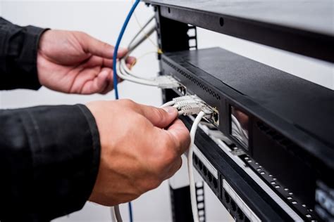 Premium Photo Technician Connecting Network Cables To Switches Connecting Cables In Server
