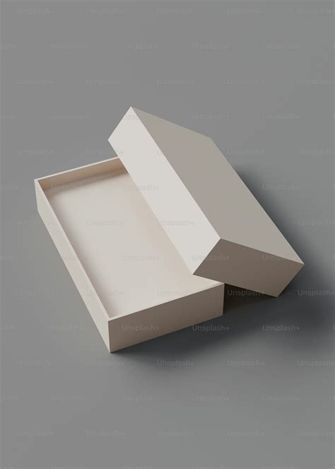 회색 표면에 열려 있는 흰색 상자 사진 Unsplash의 모형 이미지