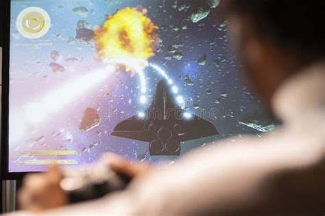 Man In Living Room Playing Science Fiction Videogame On Gaming Console Shooting Lasers Stock