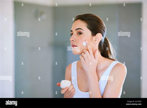 Keeping Her Skin Clean And Smooth An Attractive Young Woman Applying