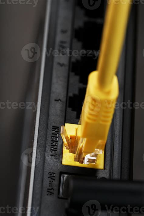 A Yellow Patch Cord Is Inserted Into The Wi Fi Port Of The Router To