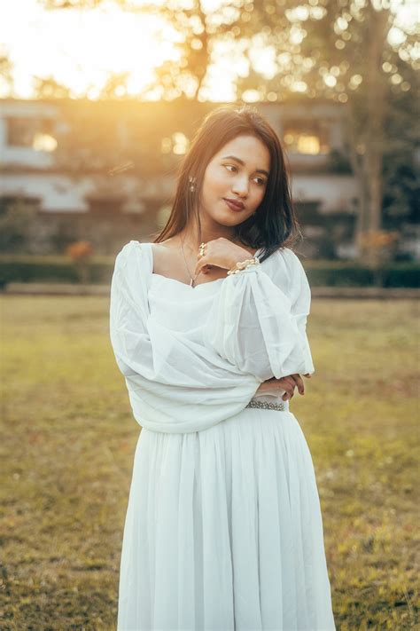 A Young Woman In A White Dress At Sunset Photo Free Fashion Image On