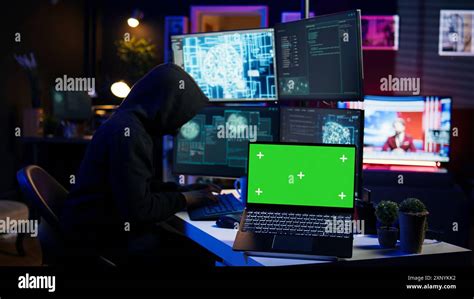 Hacker In Hidden Place Using Green Screen Laptop To Deploy Malware On