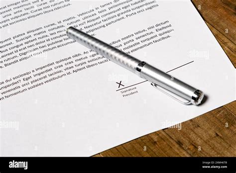 Paper Contract Form With A Signature About To Be Signed On A Signature
