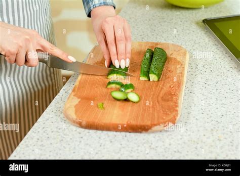 Female Hands Cutting Cucumber Stock Photo Alamy