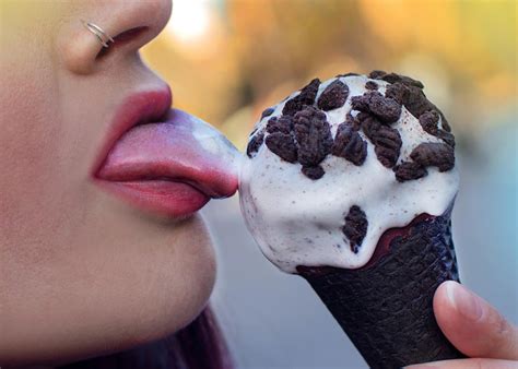 Premium Photo Girl Sensually Licks Oreo Ice Cream With The Tip Of Her