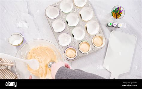 Flat Lay Step By Step Scooping Cupcake Batter Into A Foil Cupcake Liners To Bake Vanilla Mardi