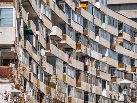 Worn Out Apartment Building From The Communist Era Against Blue Sky In