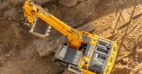 양동이가 솟아오른 건설 현장 지상의 굴삭기 상단 공중 보기 사진 Unsplash의 불도저 이미지