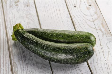 Raw Young Small Green Zucchini Premium Photo
