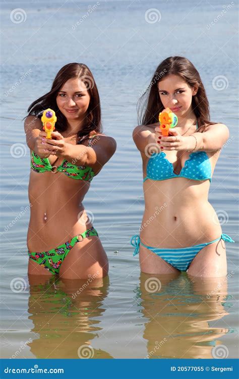 Two Girls In Bikini Play With A Water Guns Stock Image Image Of