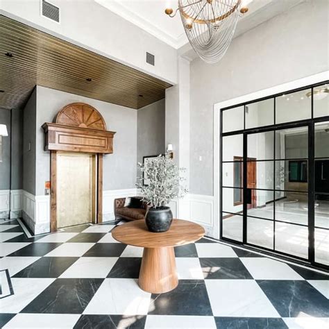 Grand Foyer Featuring Tile Floors Art Deco Elevator And Sleek Steel