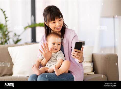 Asian Mother With Baby Son Taking Selfie At Home Stock Photo Alamy