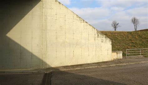 Exit Of A Road Underpass Made Of Concrete With Grass Trees And Cloudy