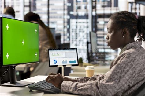 Woman At Her Desk Working On Data Analysis Next To Mockup Display Stock