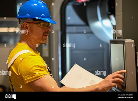 Industrial Engineer Managing A Cnc Milling Machine Using A Computer