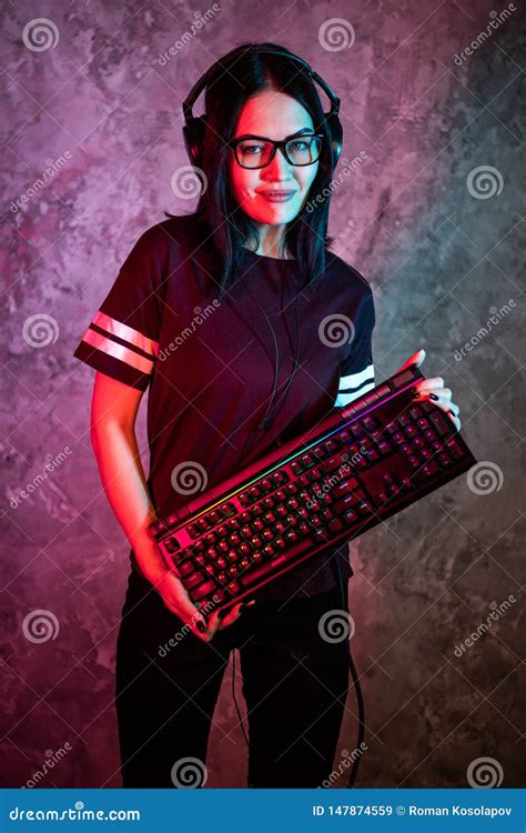 Beautiful Friendly Pro Gamer Streamer Girl Posing With A Keyboard In Her Hands Wearing Glasses