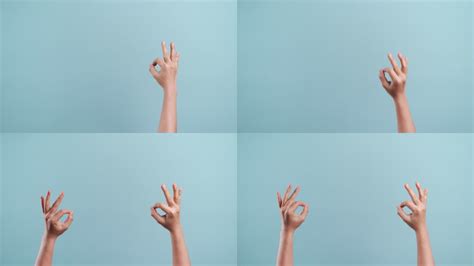 女人的手在复印空间上用手指做“ok”手势，在蓝色背景下移动手势视频素材下载编号9989182光厂vj师网