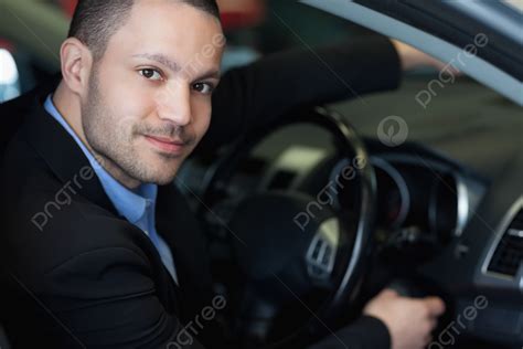 A Man Igniting The Engine While Seated On A Car Photo Background And Picture For Free Download