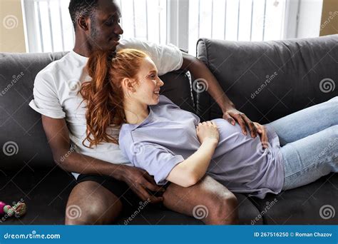 Handsome Black Guy Is Touching Pregnant Wifes Belly While Sitting On
