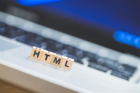 premium photo html web language wooden cubes with letters html lying on a laptop concept for html