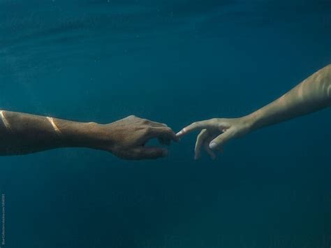 Peaceful Couple Floating In The Water From Underwater View By Stocksy Contributor Jordi Rulló