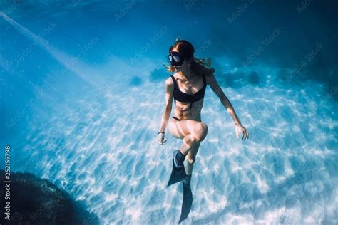 Woman Freediver In Bikini Over Sandy Sea With Fins Freediving