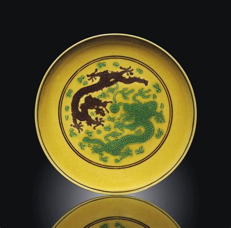 A Yellow Ground Aubergine And Green Enamelled Dragon Dish