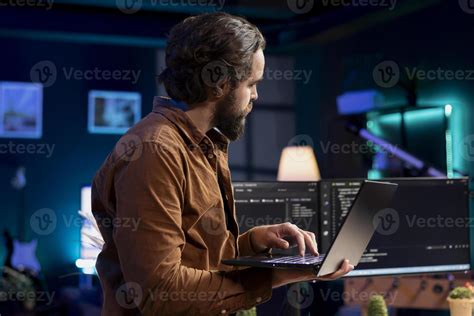 Man Doing Software Quality Assurance Reading Source Code On Laptop Crosschecking With Computer
