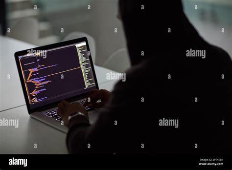 Manipulating Your Info With Malicious Intent An Unrecognisable Hacker Using A Laptop Stock