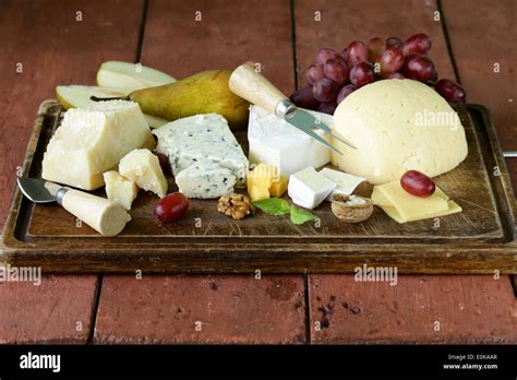 Cheeseboard With Assorted Cheeses Parmesan Brie Blue Cheddar Stock