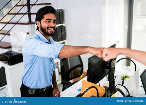 Cheerful Indian Businessman Partners Making Fist Bump With A Smile As A Symbol Of Teamwork