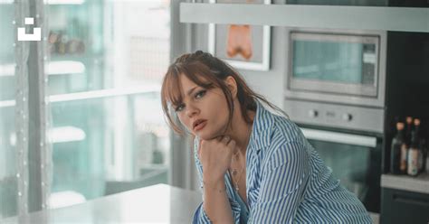 파란색과 흰색 줄무늬 긴 소매 셔츠와 파란색 데님 청바지에 앉아 있는 여자 사진 Unsplash의 무료 밴쿠버 이미지