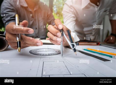 Engineer Or Architect Meeting For Project Working With Partner And Using Divider Compass Tools
