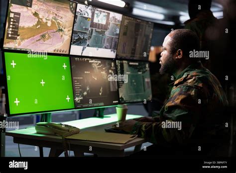 Military Early Warning Systems Operator Monitoring Enemy Aerial Attacks Using Green Screen