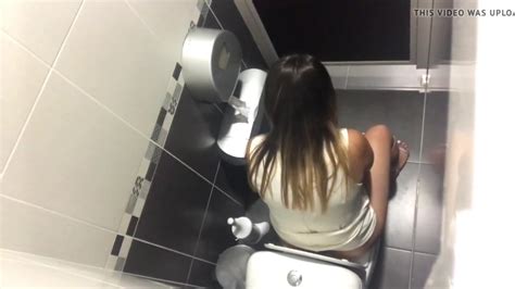 Girls Sits On Toilet Whilst Voyeur Lurks Above