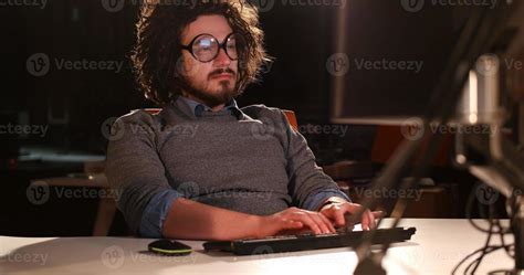 Man Working On Computer In Dark Office 11313917 Stock Photo At Vecteezy