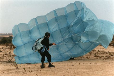 A Member Of The Explosive Ordnance Disposal Eod Team Gathers Up His Parachute After