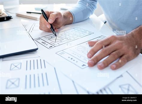 Close Up Of Unrecognizable Ui Engineer Sitting At Desk And Making