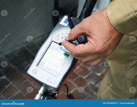 Radiation Detector Testing Dosimetrist Holding A Portable Gamma Radiation Dosimeter Set On A