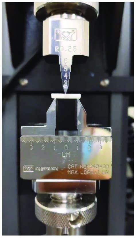 specimen seated on universal testing machine for testing flexural
