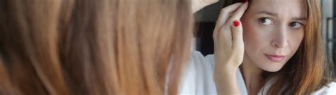 Woman Examining Her Scalp DermCo