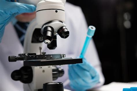 Premium Photo Male Medical Scientist Examining Specimen Using Microscope In Modern Laboratory