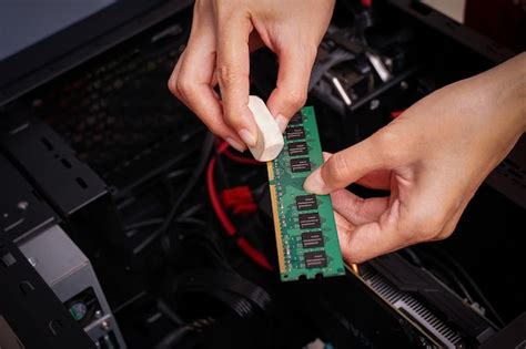 Premium Photo Cleaning A Random Access Memory Or RAM Using An Eraser