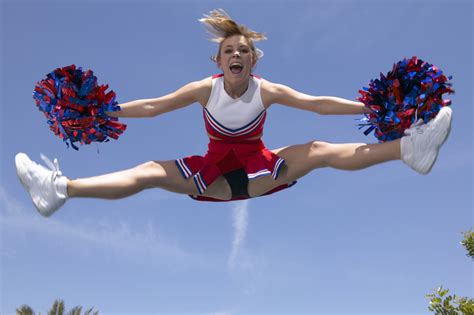 Airborne Cheerleader With Pompoms Free Photo Download Freeimages