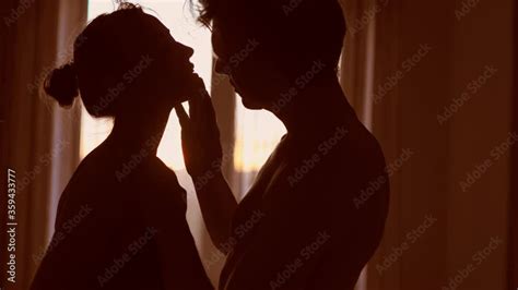 Silhouette Two Toung Lovers Touching Ambracing And Kissing Each Other