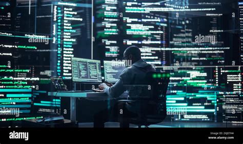 Black Male Developer Thinking And Typing On Computer Surrounded By Big