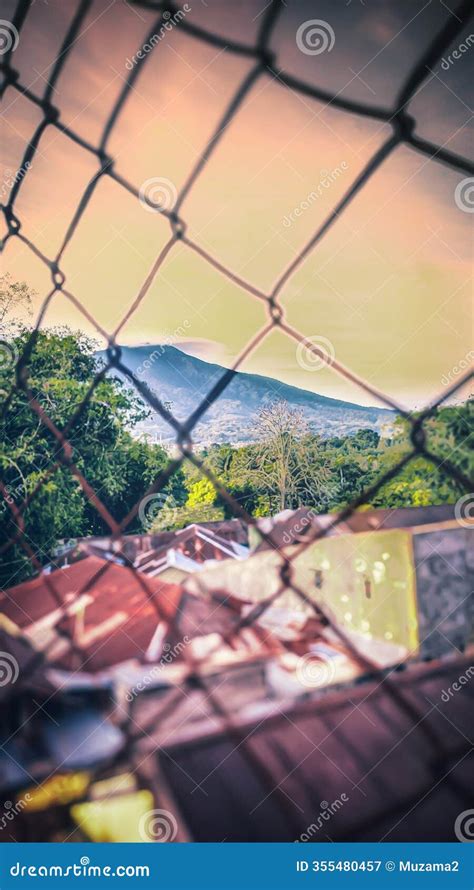 The Intricate Pattern Of The Wire Mesh Frames A Stunning Vista Of Mount