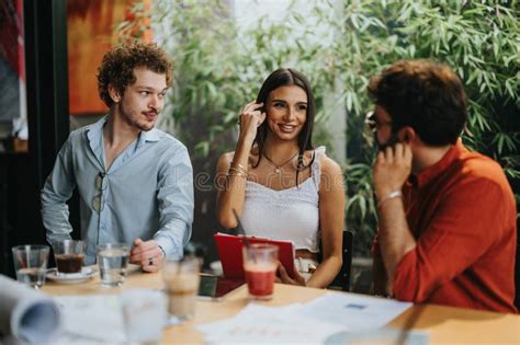 Adult Architects And Engineers Discussing A New Project Outdoors They Review Blueprints