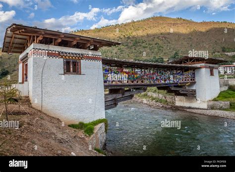 Bridge With Prayer Flags Over Wang Chhu River In Thimphu Bhutan Stock
